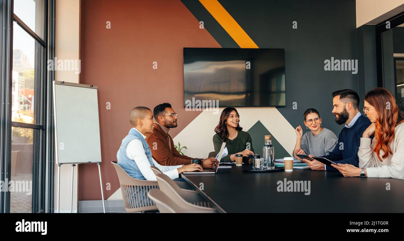Group of multicultural businesspeople having a meeting in a boardroom ...