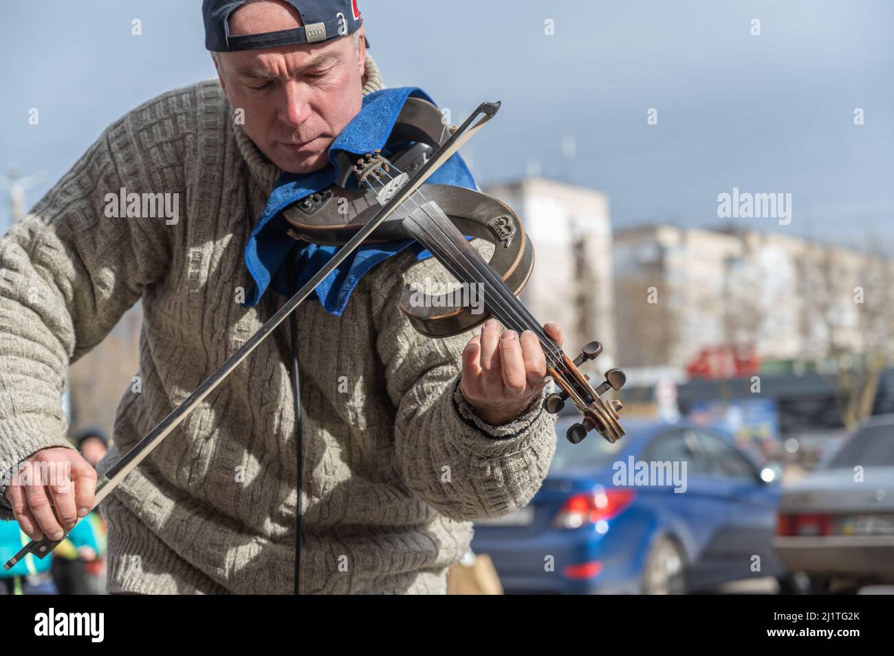 Portrait of a street musician during a concert. A mature man playing ...