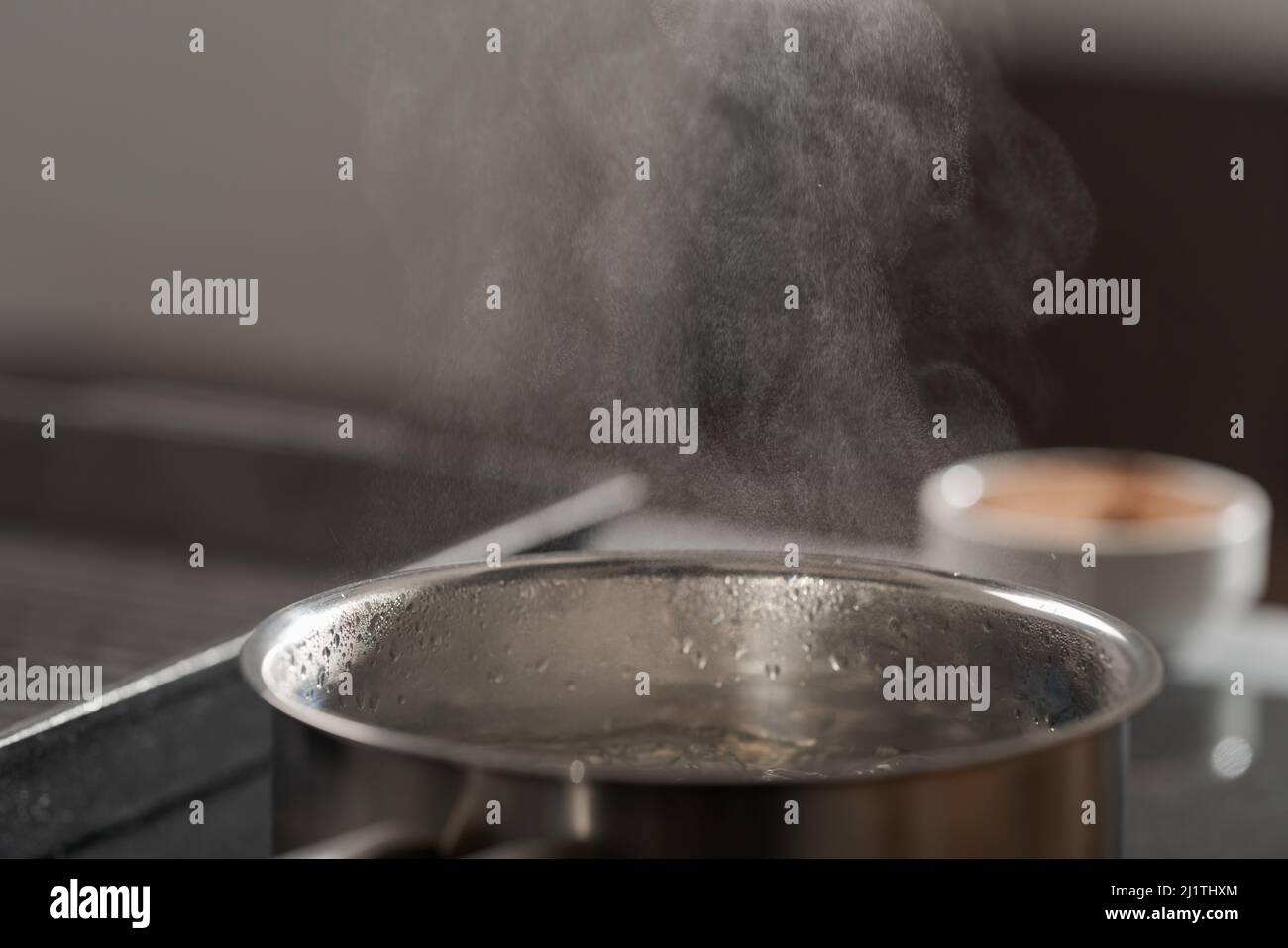 Saicepan with hot boiling water closeup, shallow focus Stock Photo - Alamy