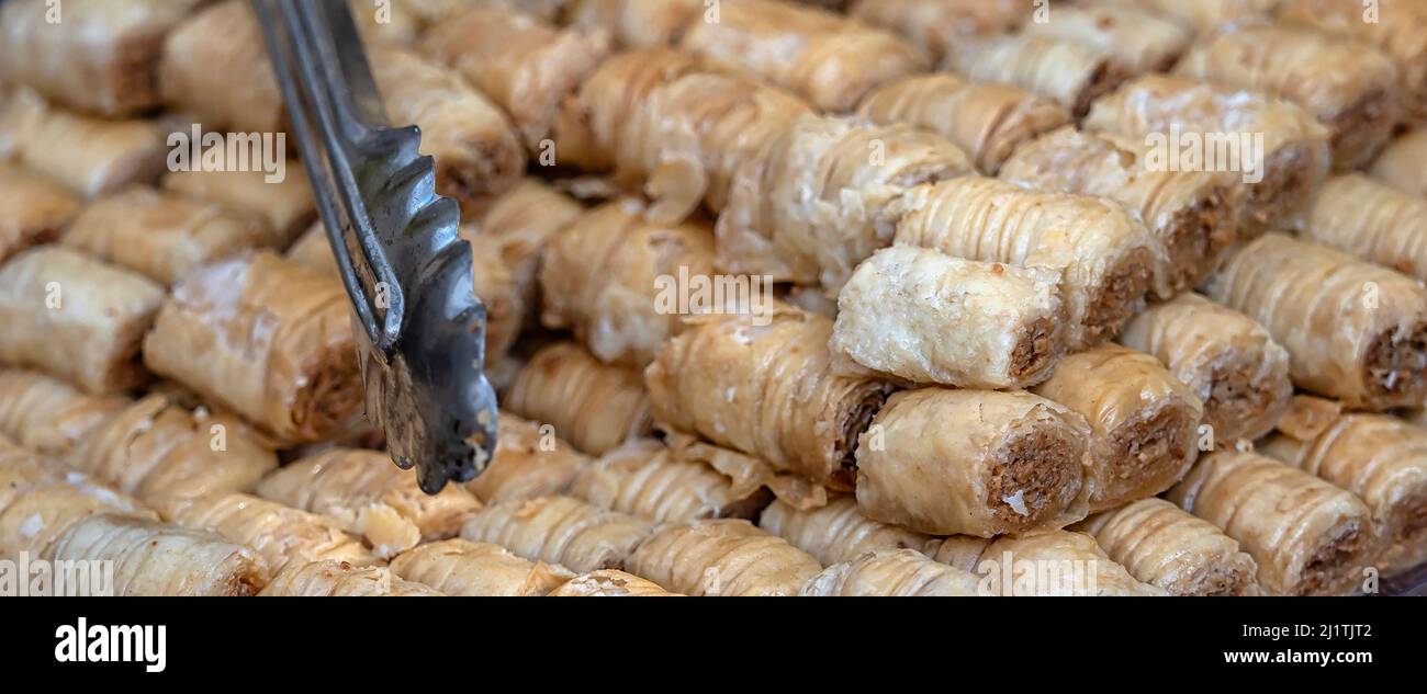 Panorama of Greek Baklava pastries at a Food Market with tongs Stock ...