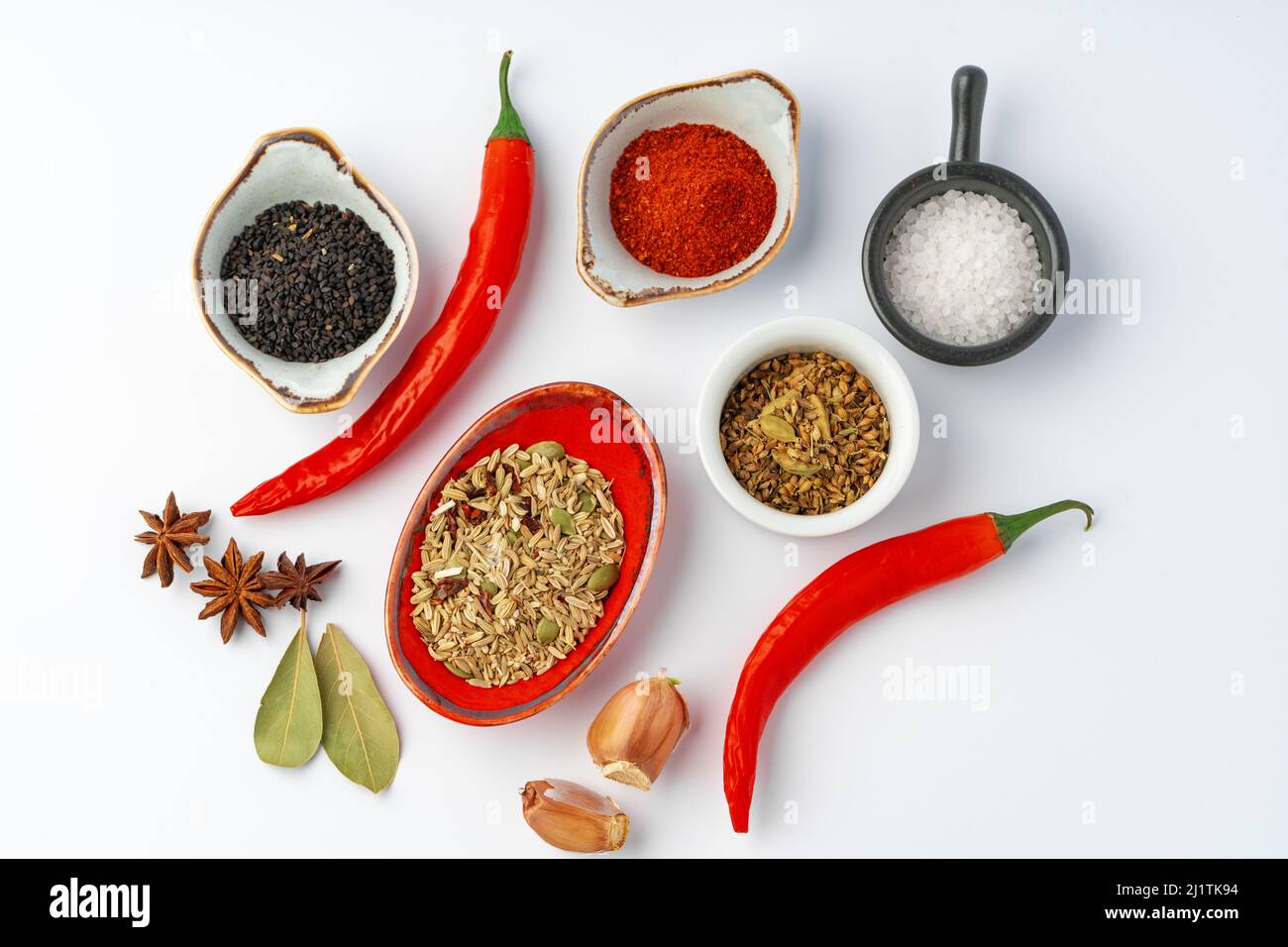 Set of spices in bowls with chili peppers on white background Stock ...