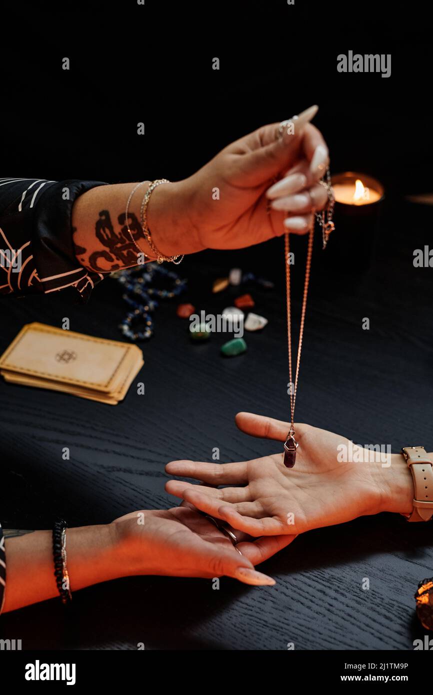 Hand holding pendulum hi-res stock photography and images - Alamy
