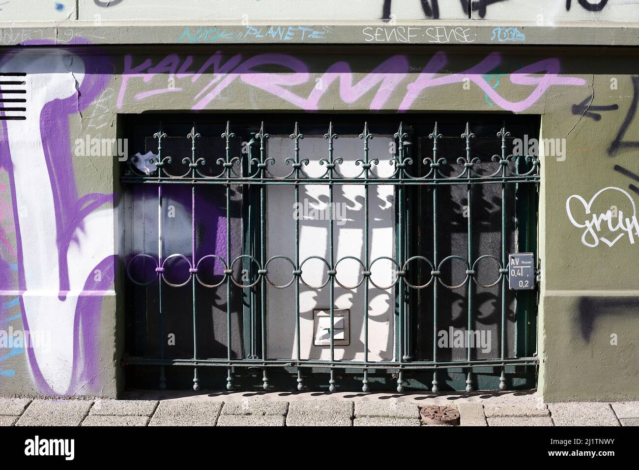Old decorated window grille in front of old cellar window on colorful ...