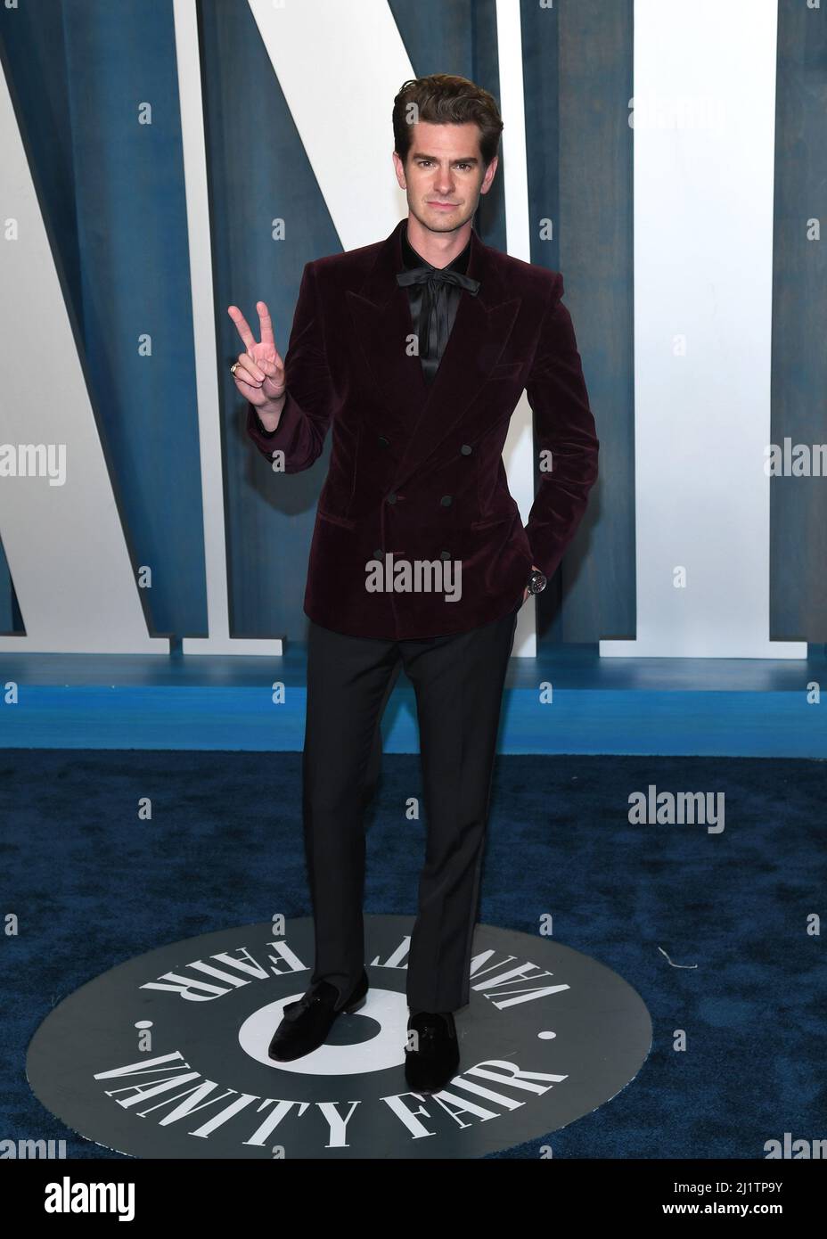 Andrew Garfield walking on the red carpet at the 2022 Vanity Fair Oscar ...