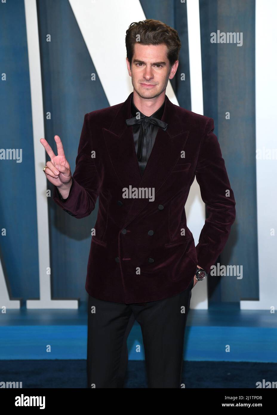 Andrew Garfield walking on the red carpet at the 2022 Vanity Fair Oscar ...