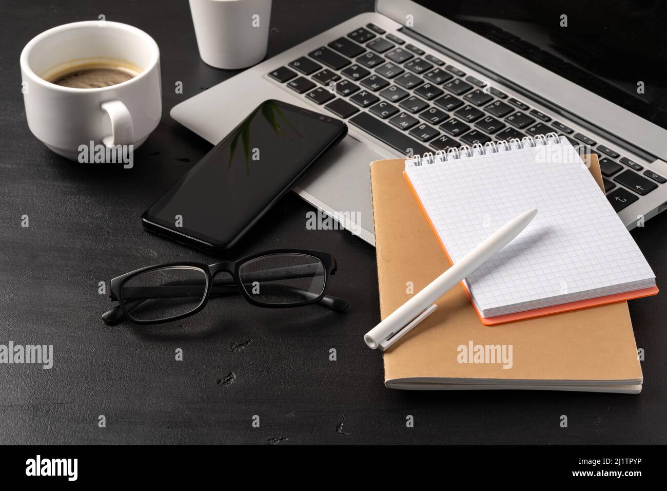 Notepad is on top of office desk table with laptop and supplies Stock ...