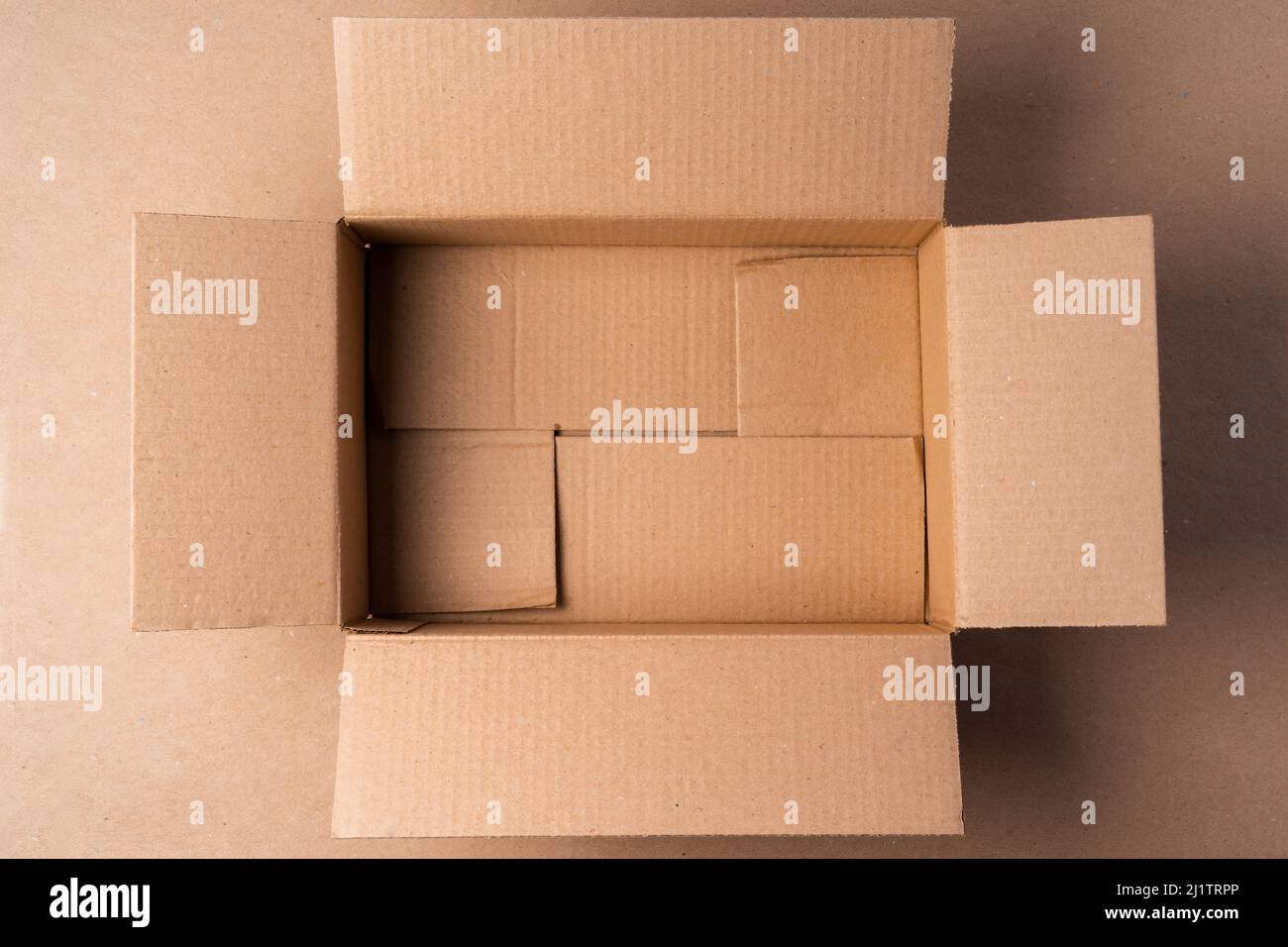 Cardboard box on beige background in studio Stock Photo - Alamy