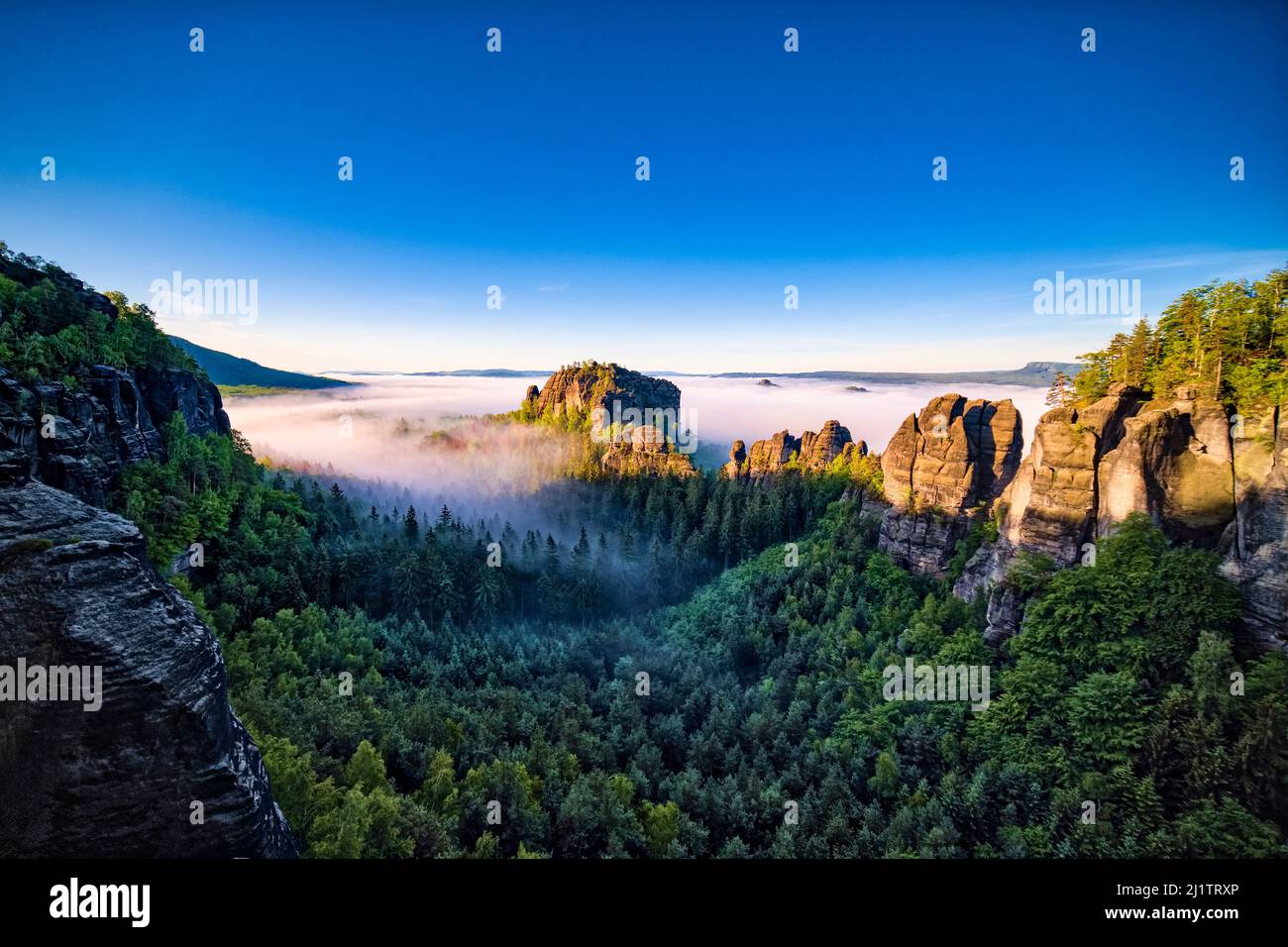Fog covered landscape with rock formations and the summit Rauschenstein ...