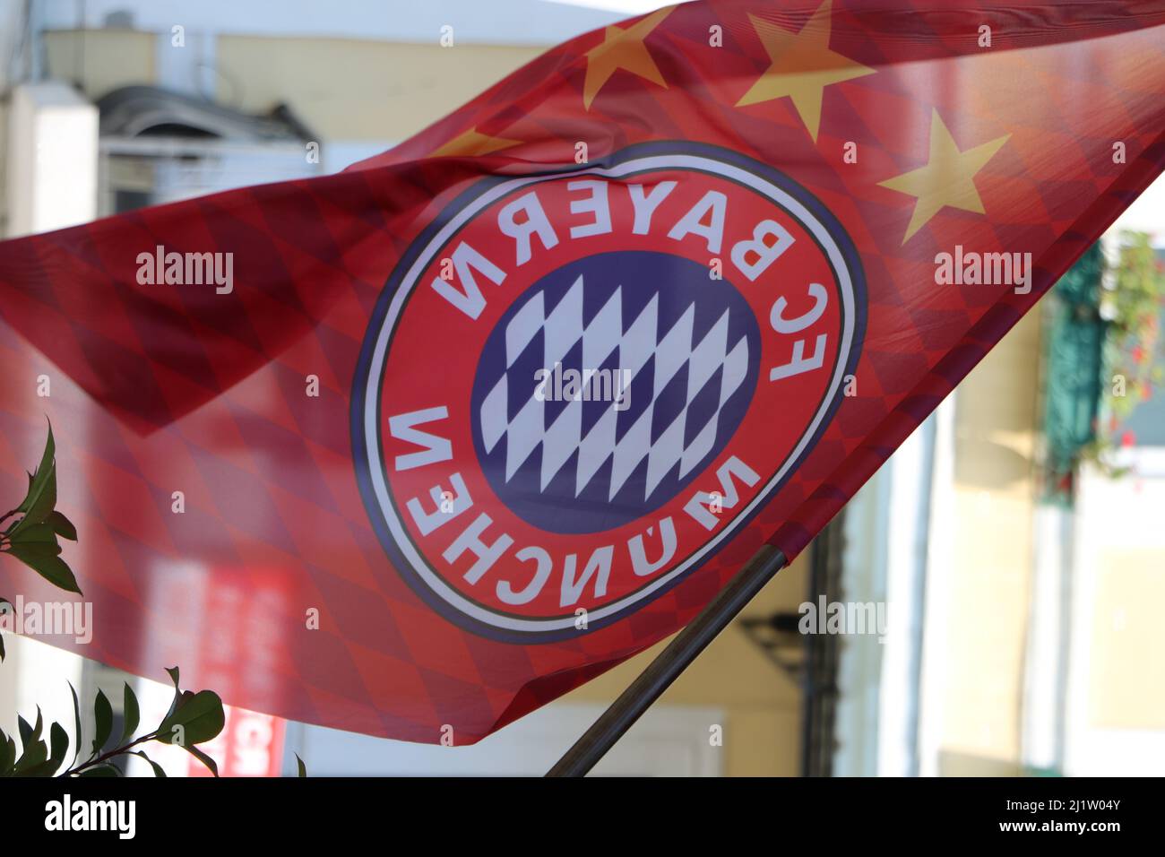 A shallow focus shot of the FC Bayern Munich flag with its logo on a ...