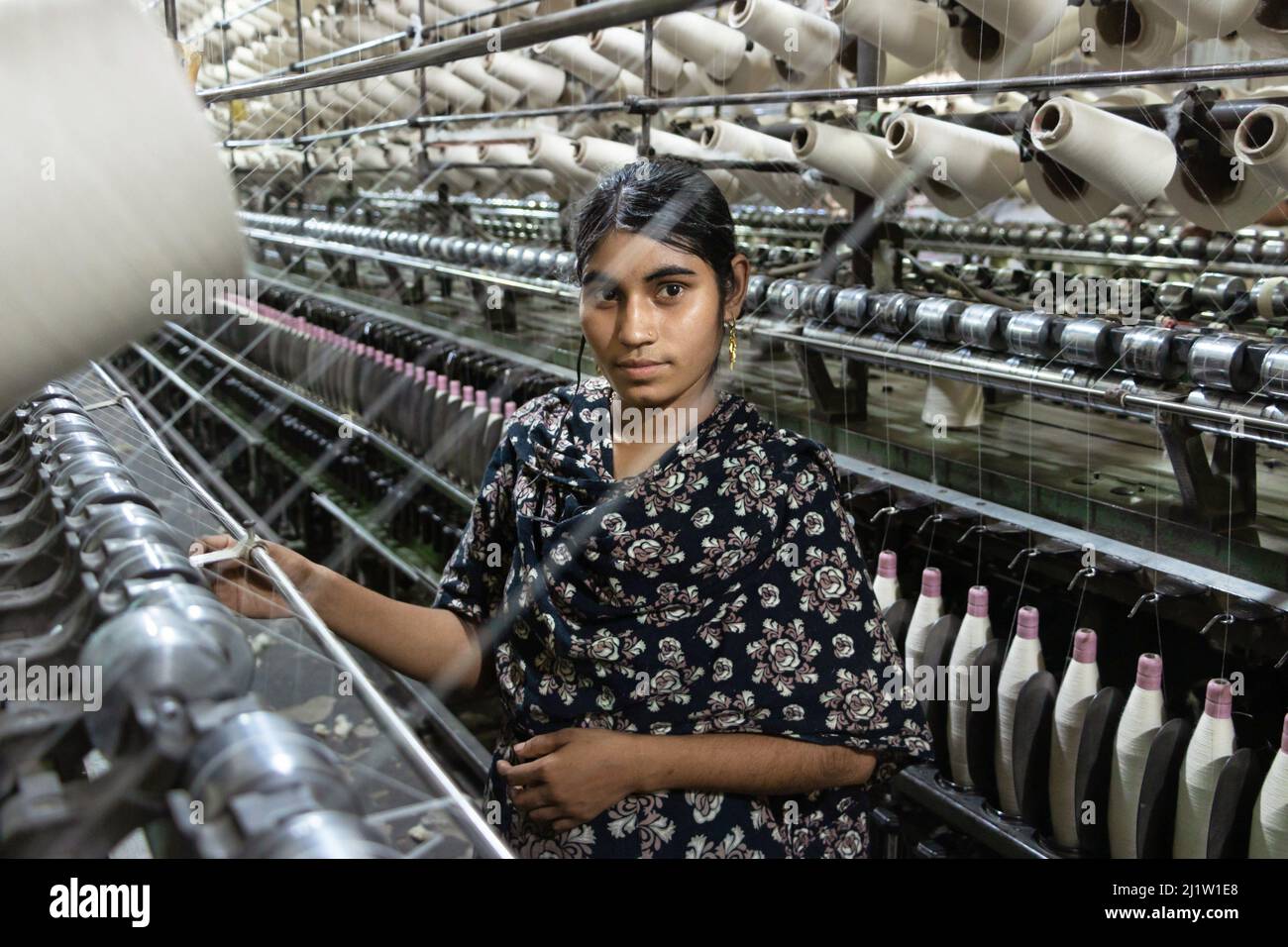Narayanganj, Dhaka, Bangladesh. 28th Mar, 2022. A worker is fixing threads as part of of yarn ...