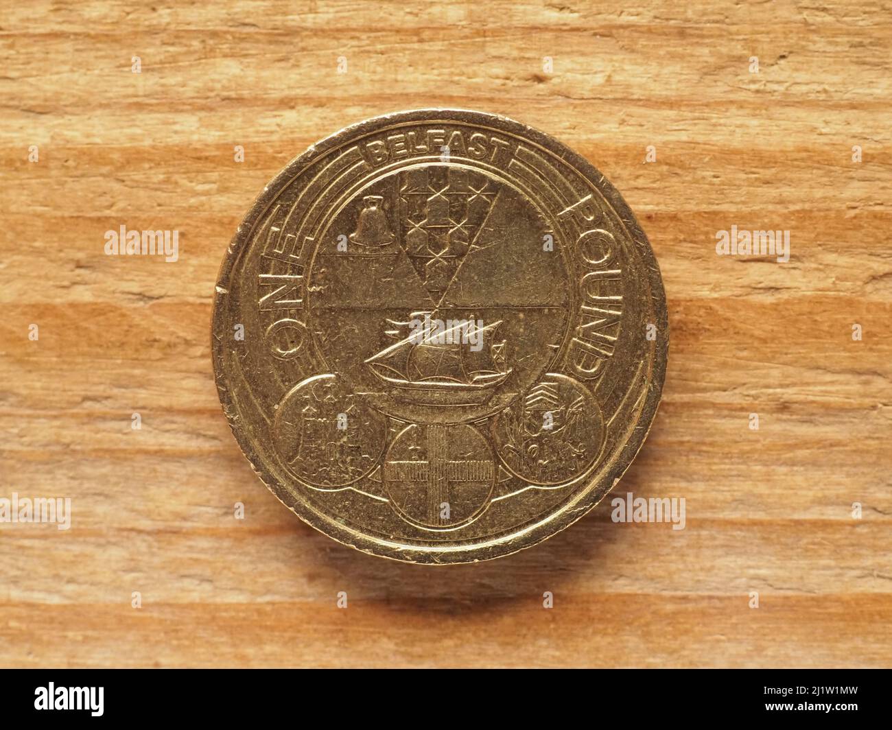 one pound coin reverse side showing badge of Belfast, currency of the ...