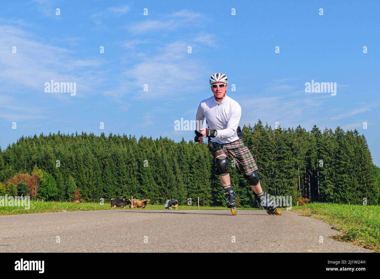 Man doing a sporty workout on inline skates Stock Photo - Alamy