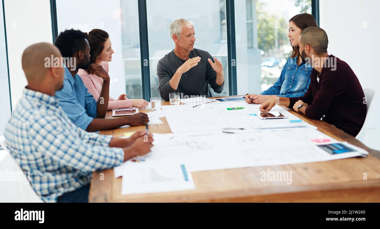 Architects do it on tables. Cropped shot of a group of architects in ... Architects do it on tables. Cropped shot of a group of architects in ...