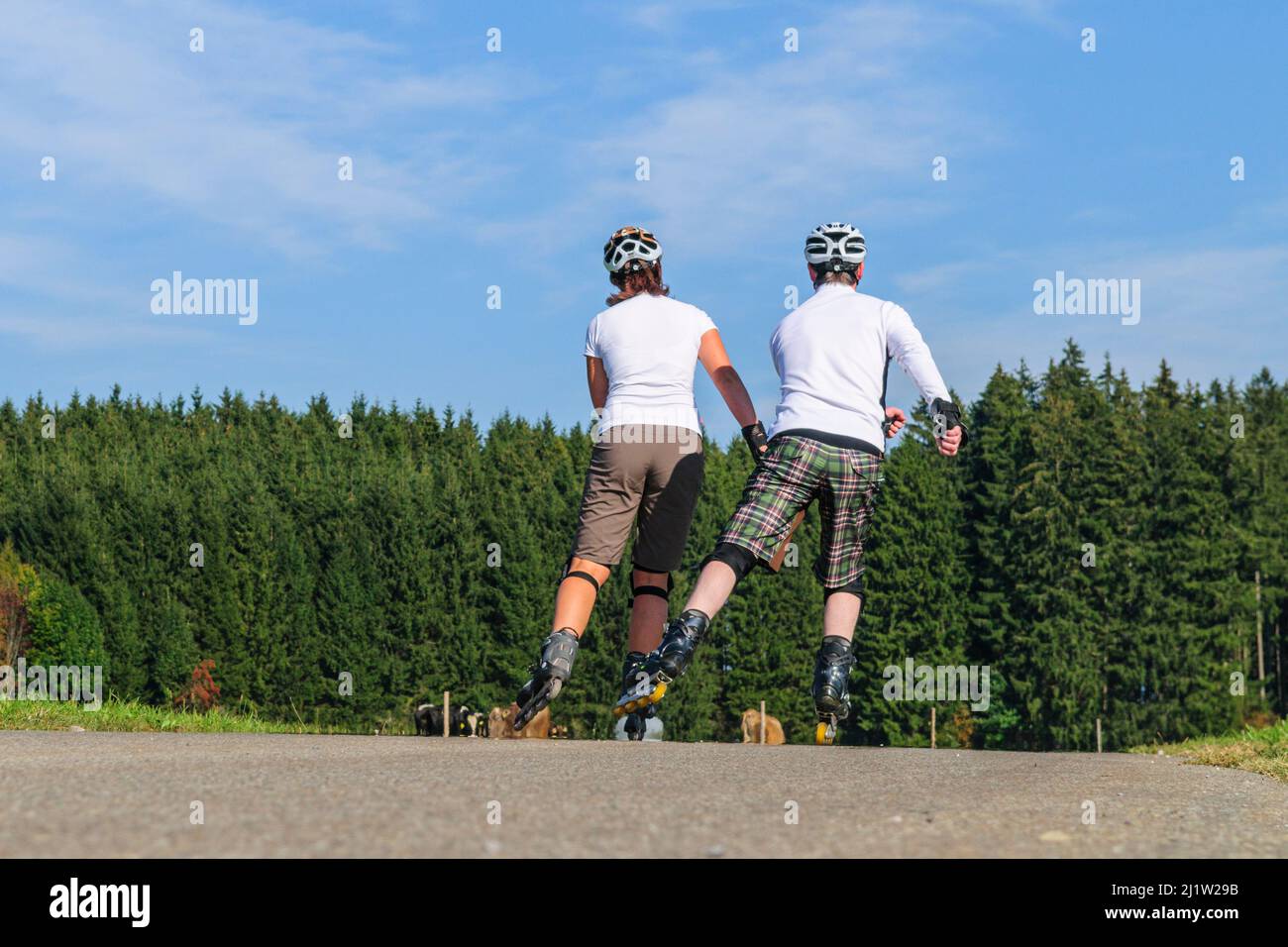 Young people having fun on roller skates in beautiful nature Stock ...