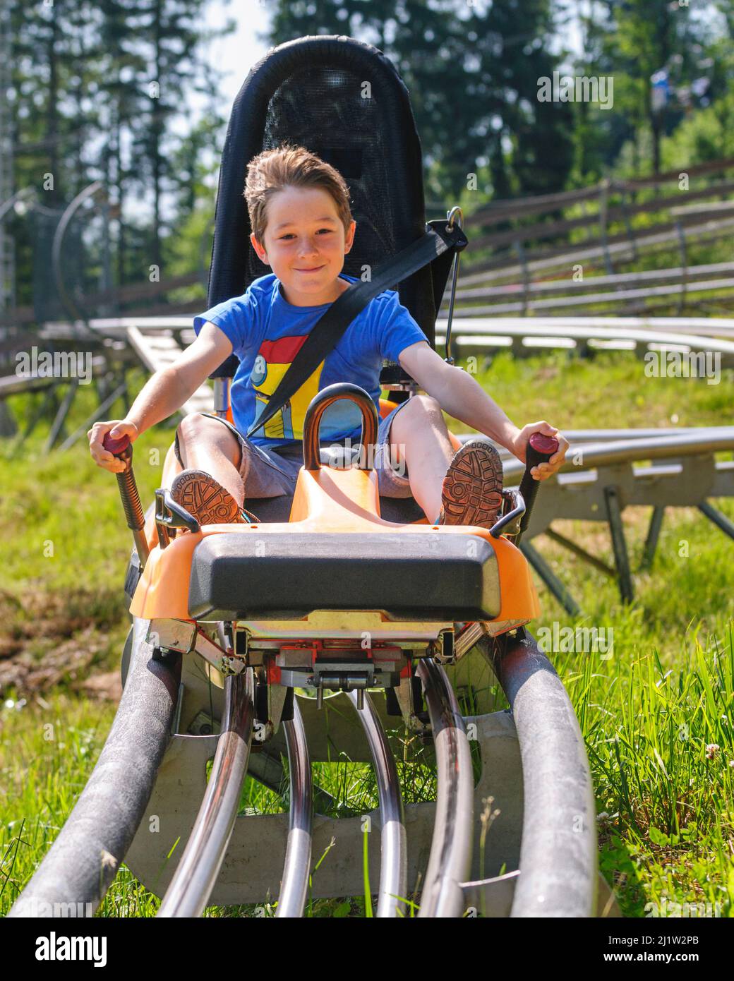 Boy on summer toboggan run Stock Photo - Alamy