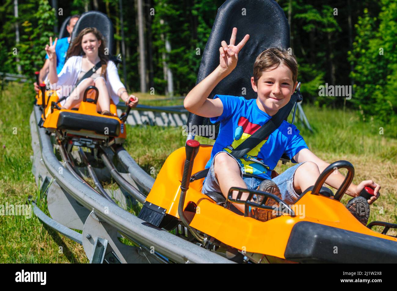 Family has a lot of fun while doing a sleigh ride in summertime Stock ...