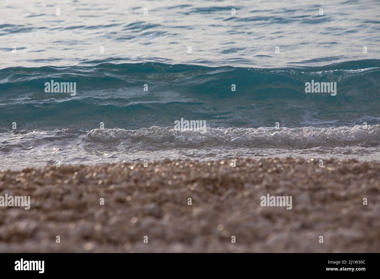 sea beach close up small waves sunset Stock Photo - Alamy