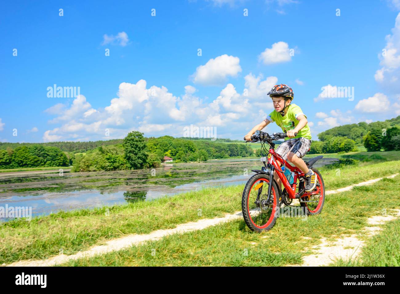 Young boy on the way in nature with his bicycle Stock Photo - Alamy