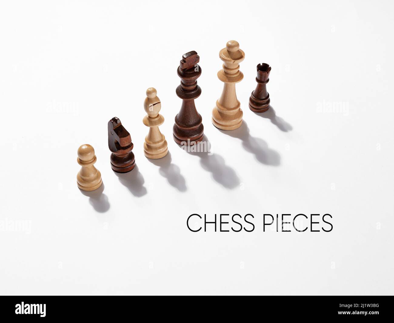 Variety of chess pieces on white background Stock Photo - Alamy