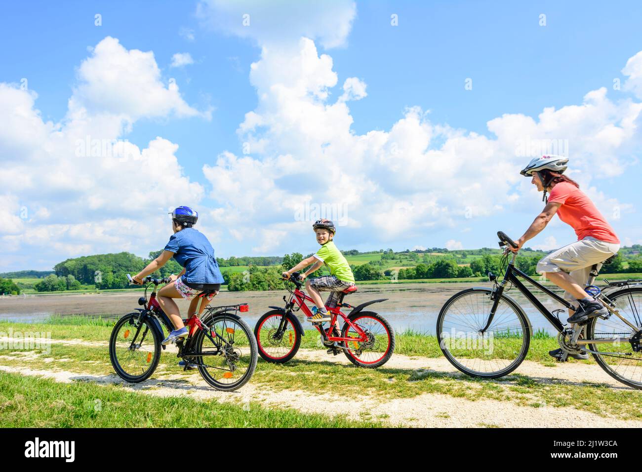 Mother with kids doing a cycling tour in beautiful nature in southern ...