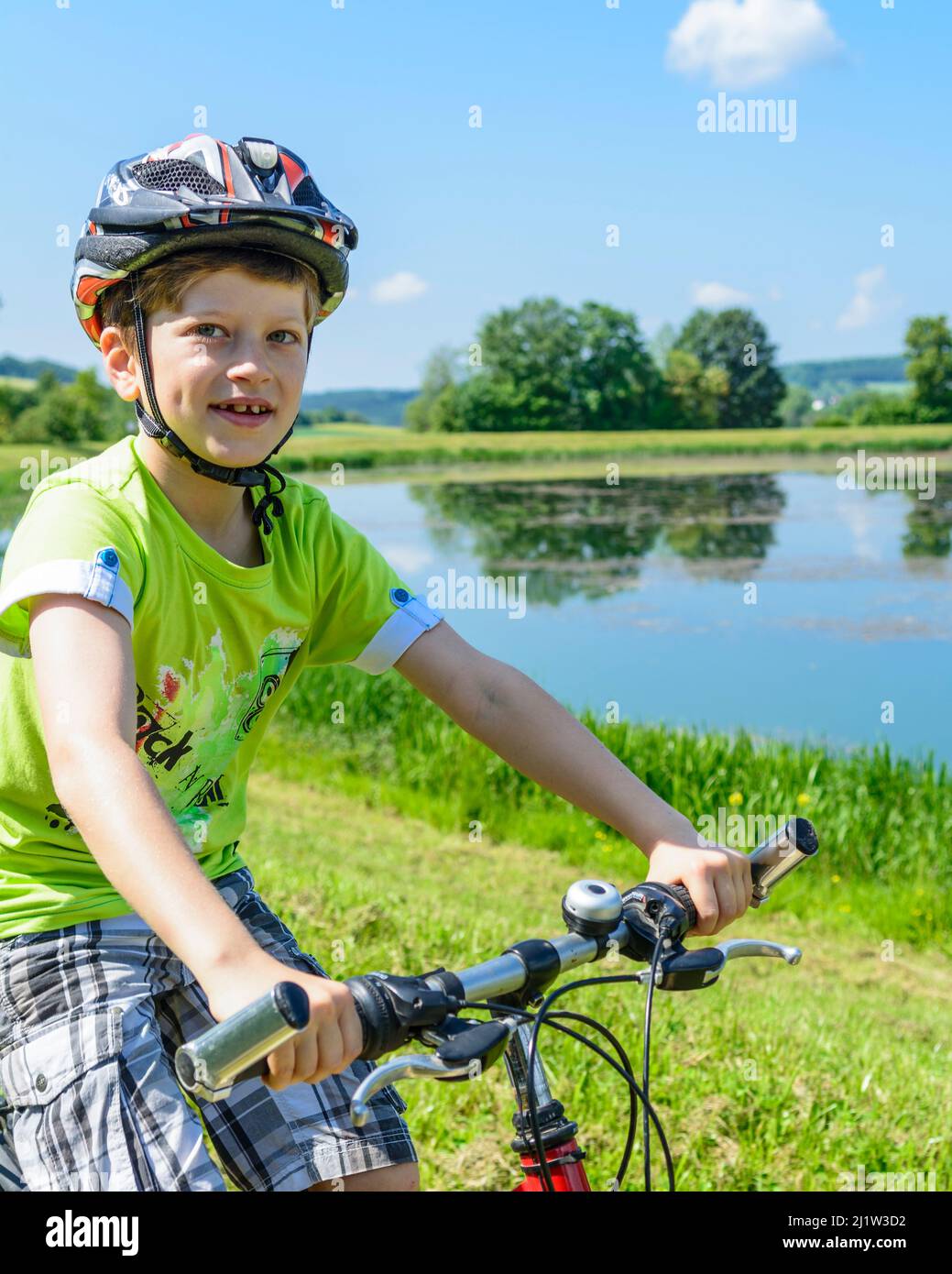 Young boy on the way in nature with his bicycle Stock Photo - Alamy