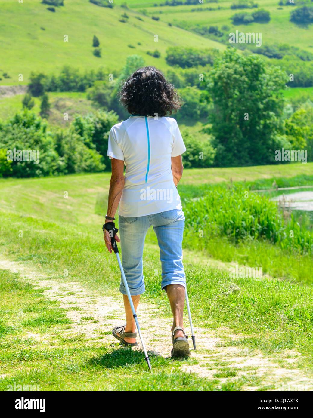 Elder woman doing Nordic Walking exercise Stock Photo - Alamy