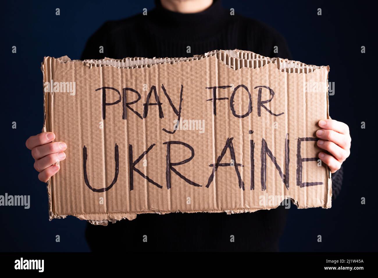 Woman holds a banner with anti-war message. Protest against the Russian ...