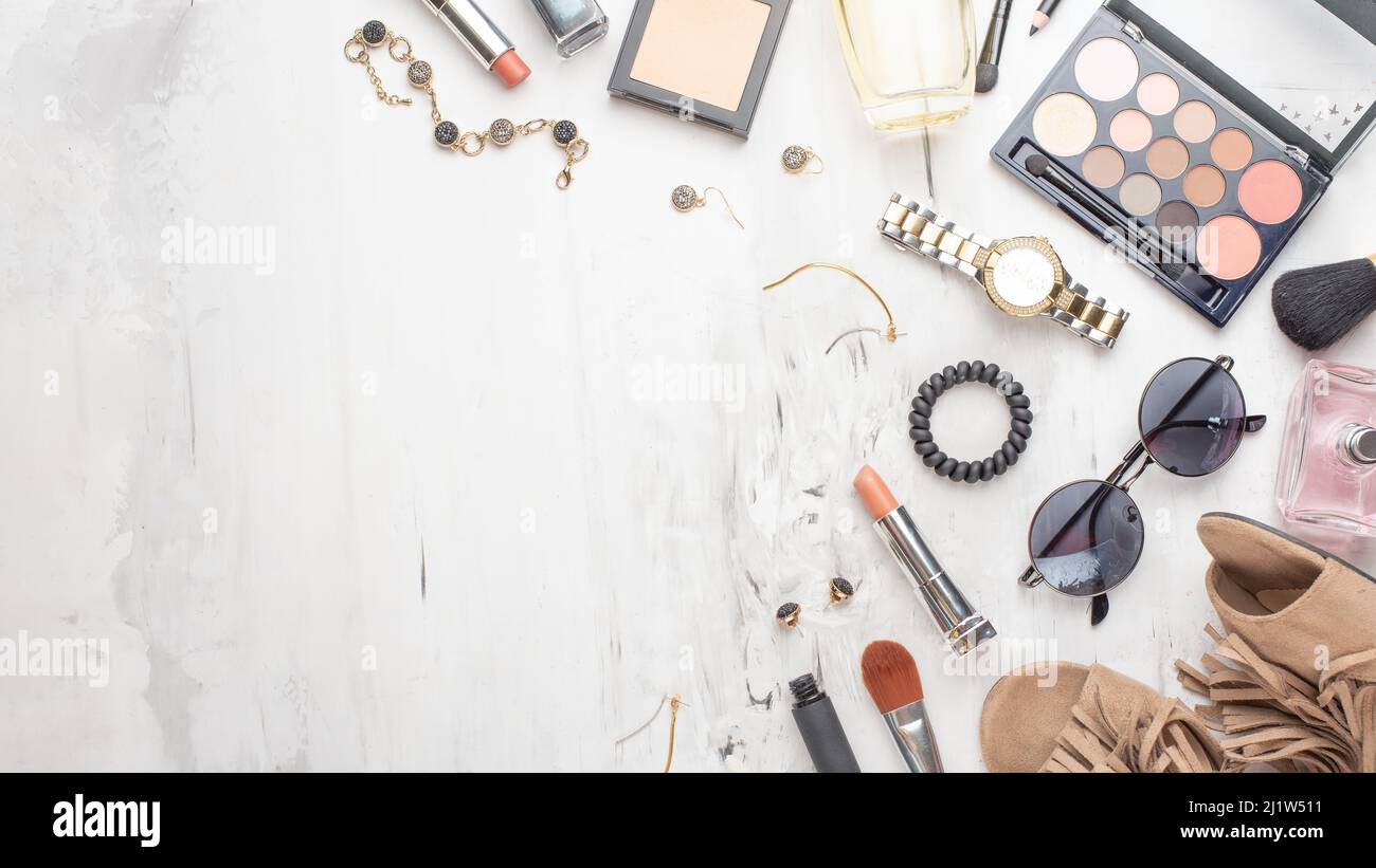 flat lay-up of female cosmetics collage frame with lipstick, brushes on ...