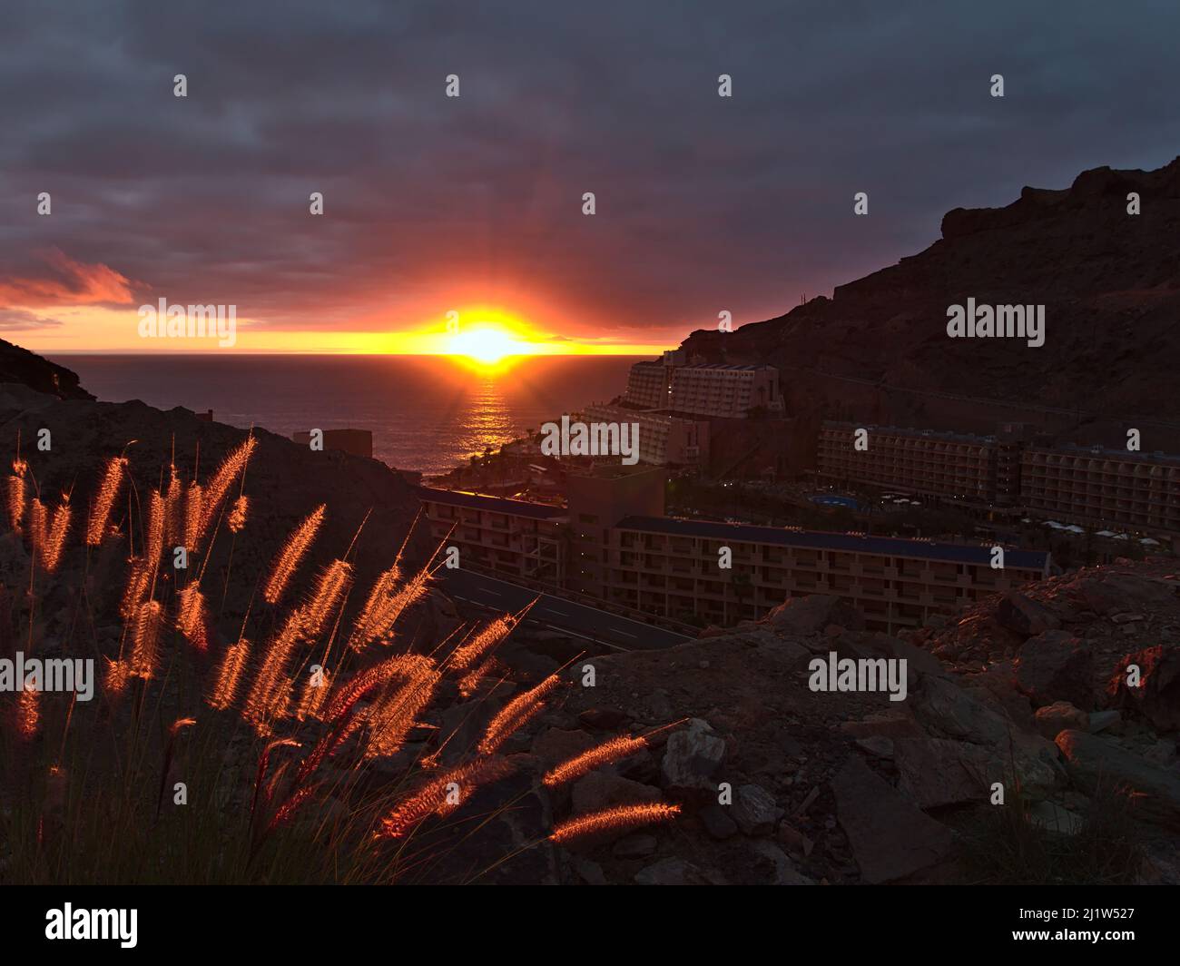 Majestic sunset above holiday resort Taurito on the southern coast of ...