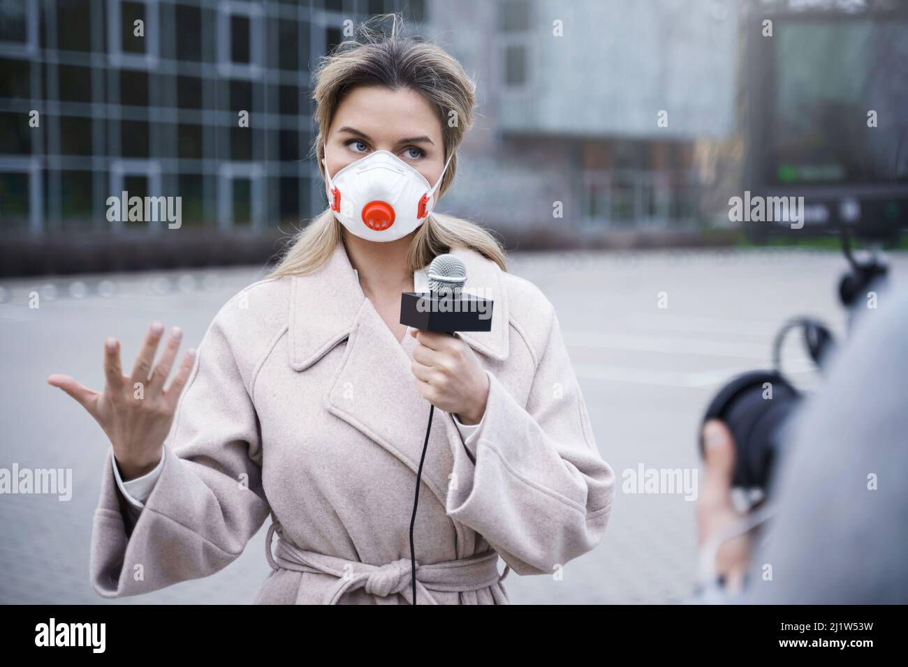TV news reporters making reportage about a virus epidemic in the city ...