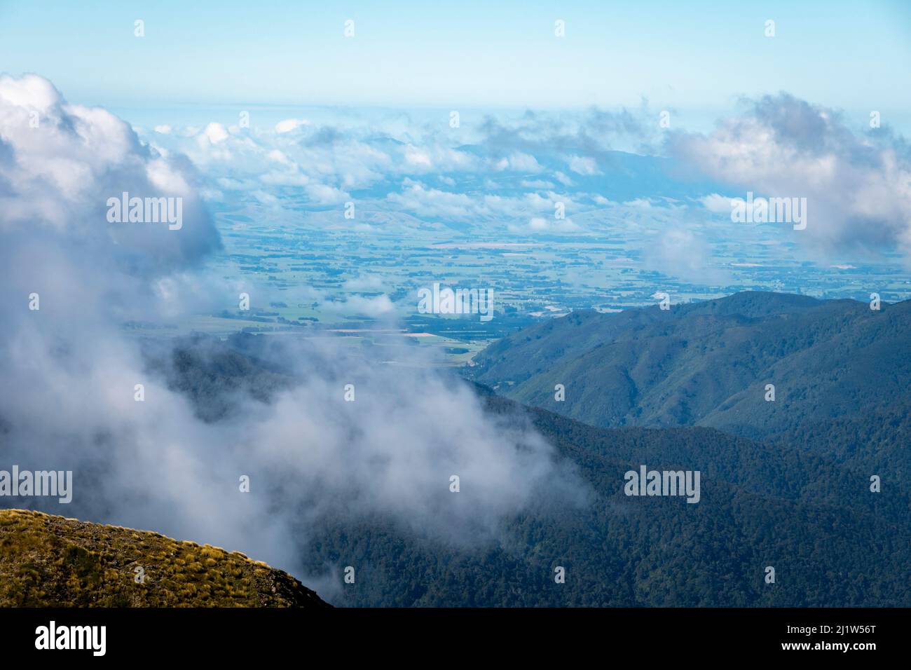 View through clouds to the Wairarapa plains, from Mount Holdsworth ...