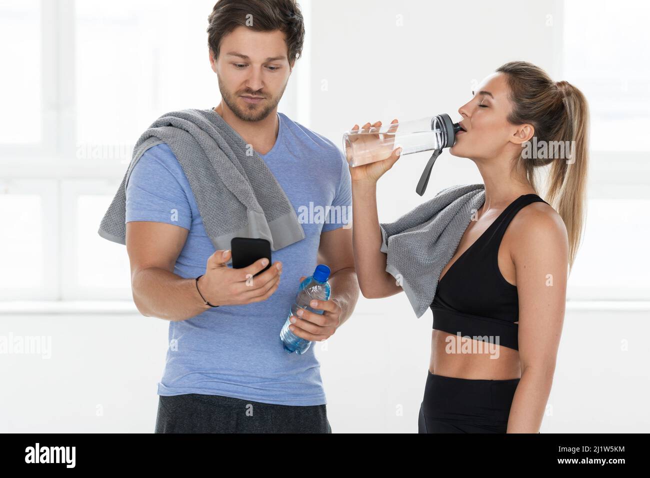 Two teammates man and woman in the gym after hard workout Stock Photo ...