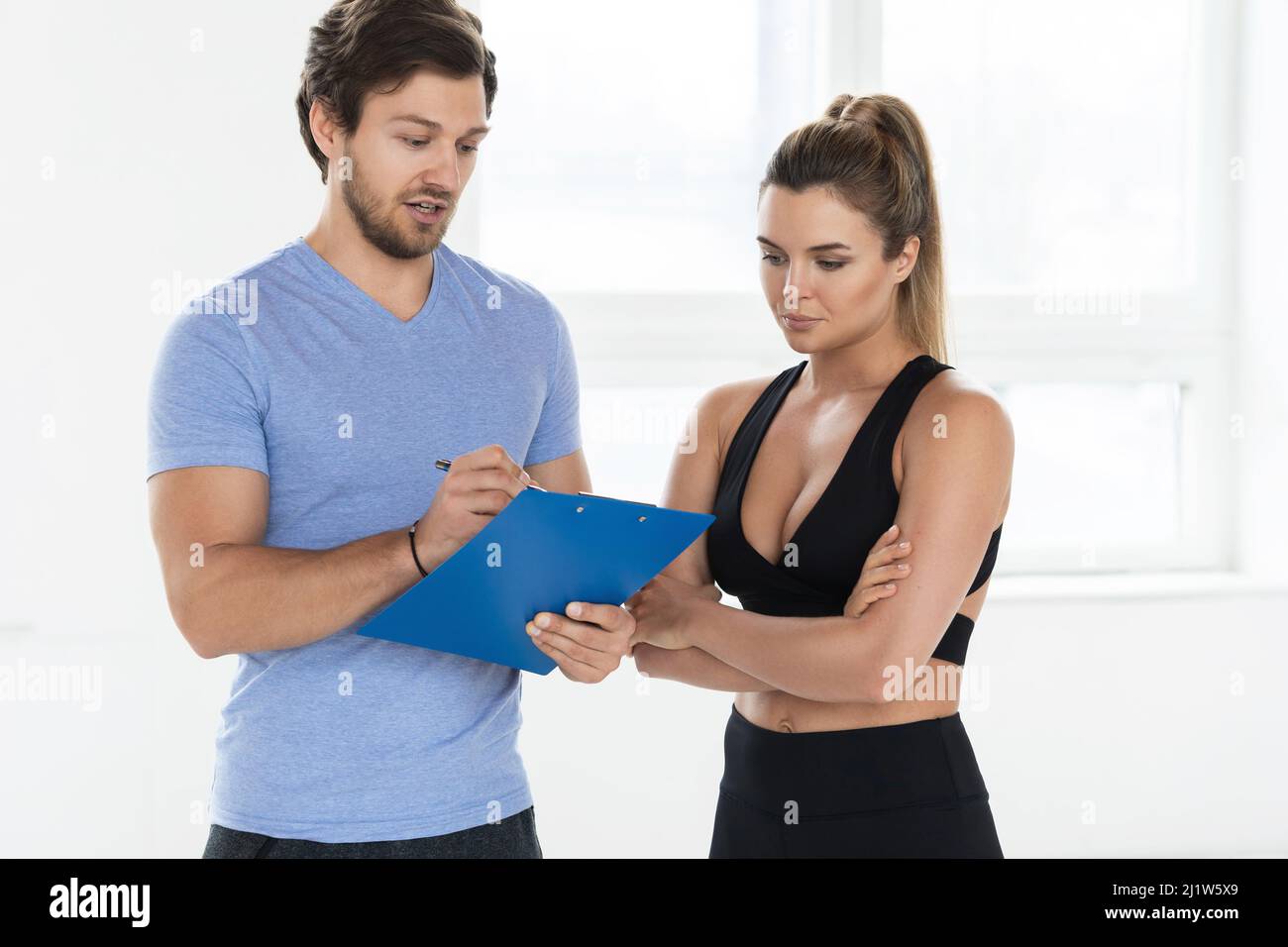 Personal fitness instructor writing individual training and diet plan ...