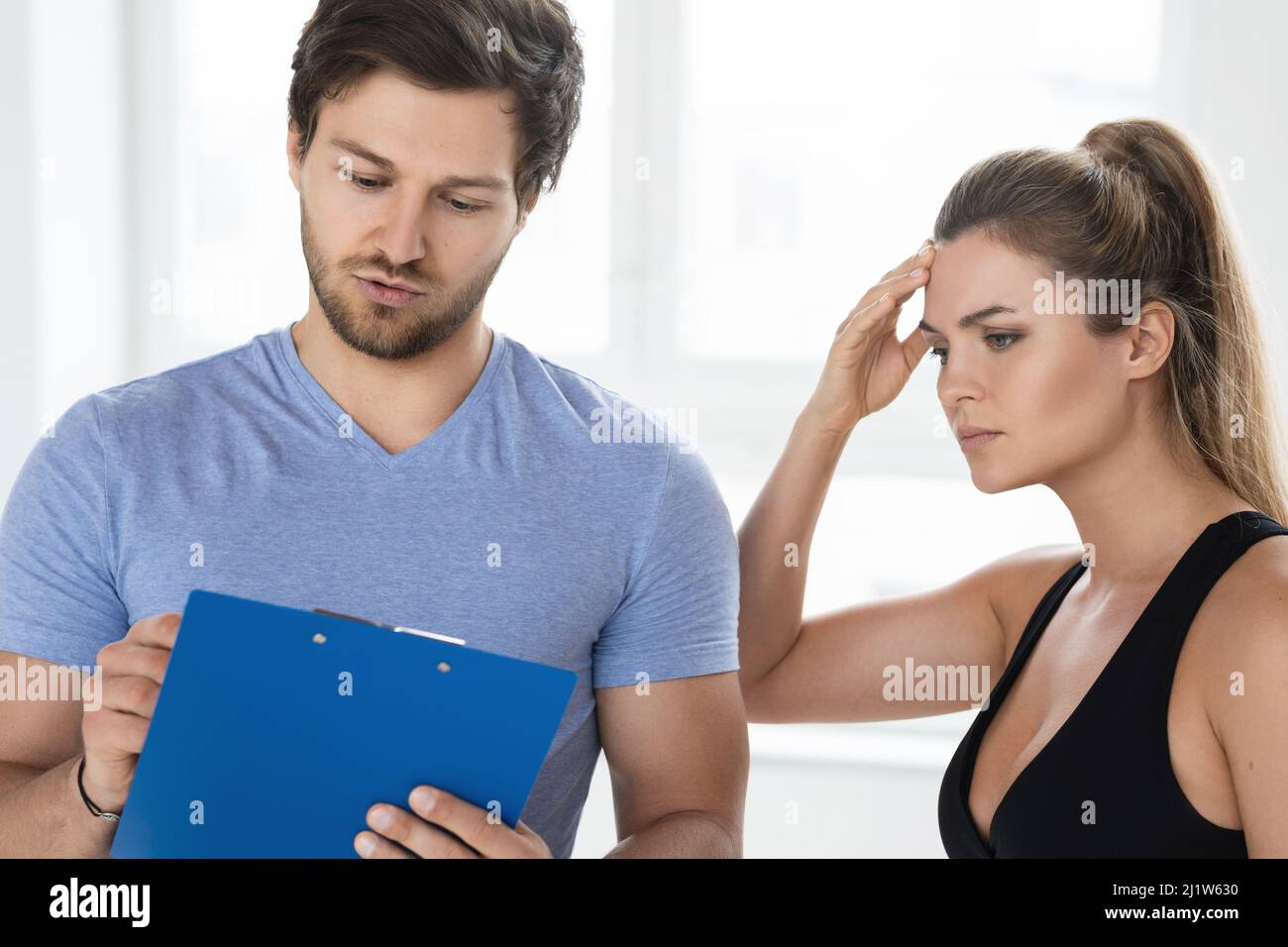 Personal fitness instructor writing individual training and diet plan ...