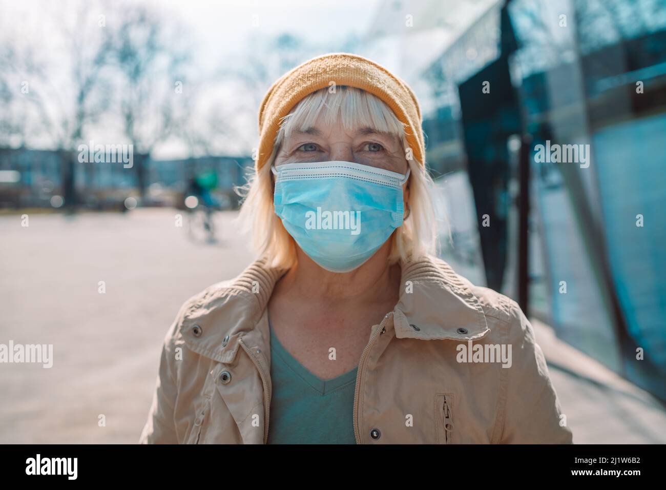 COVID-19 Social Distancing. 50s 60s woman wearing protective face mask ...