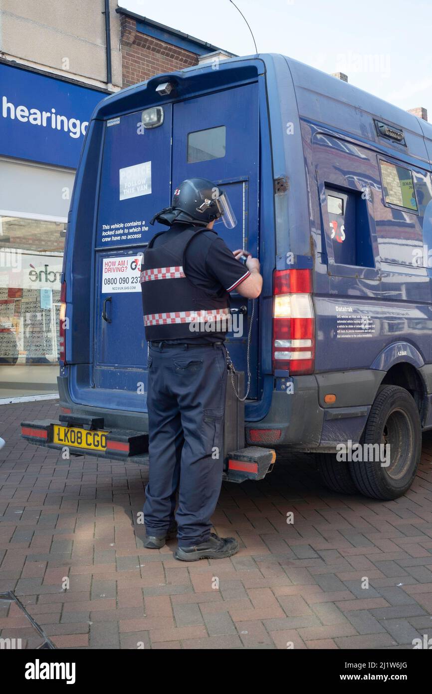 A G4S security man collecting valuables and locking them into his ...