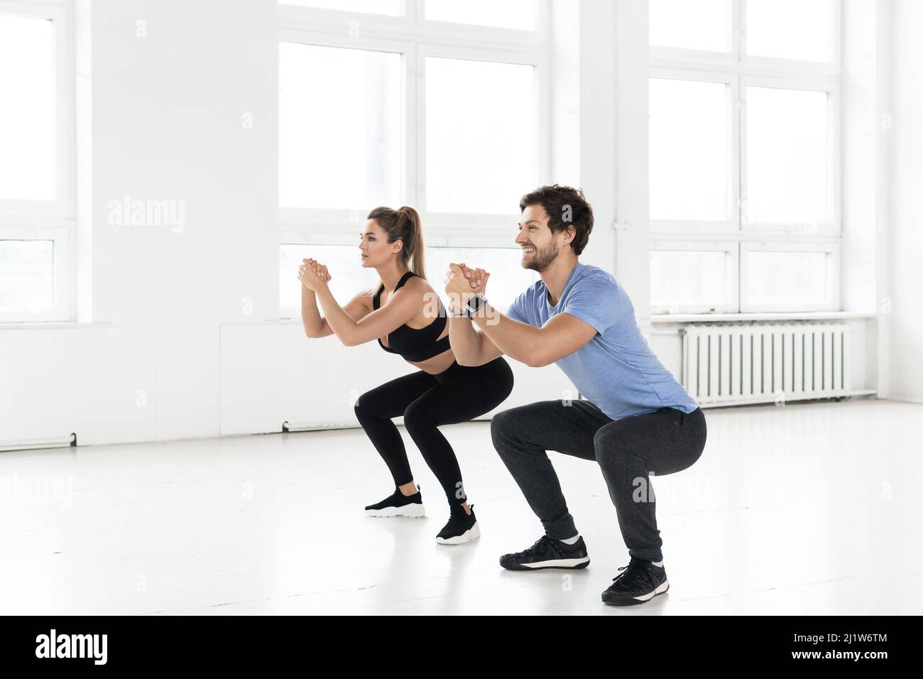 Fitness man and woman during workout with in the gym Stock Photo - Alamy