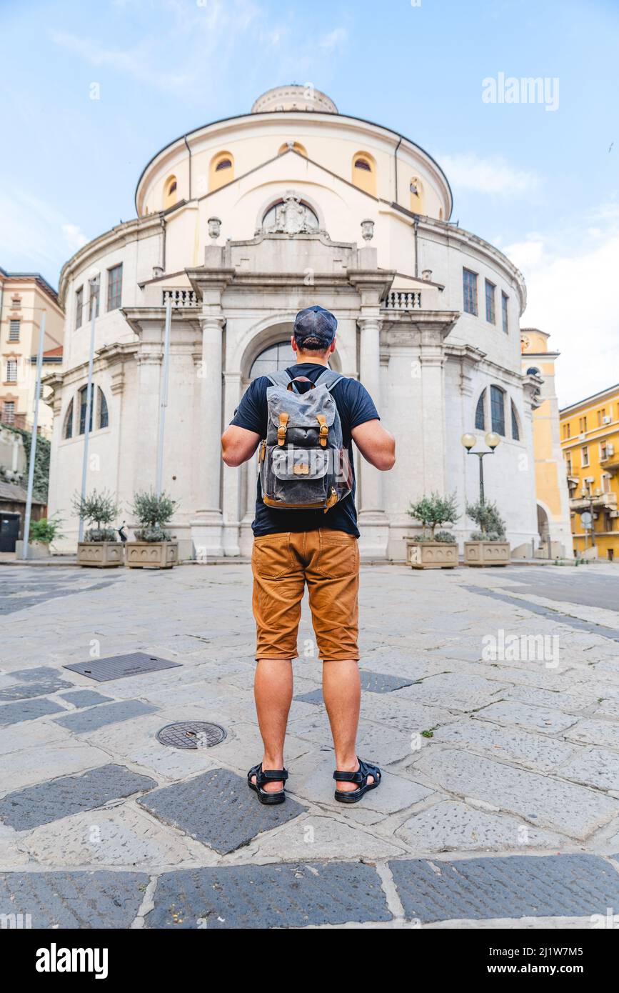 tourist man with backpack looking at saint Vitus Cathedral in Rijeka ...