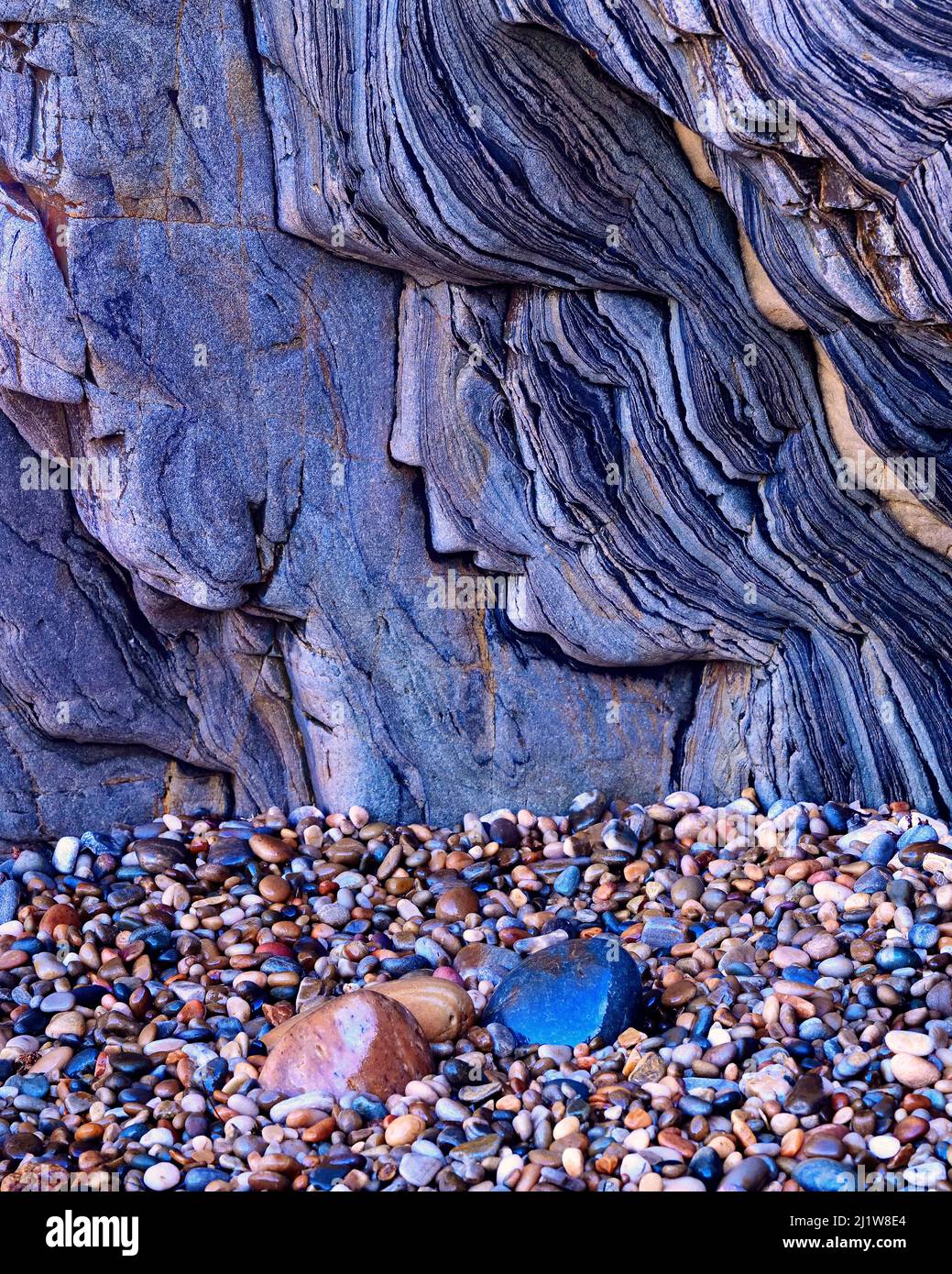 Closeup of textured surface of rough rocky formation with cracks and ...