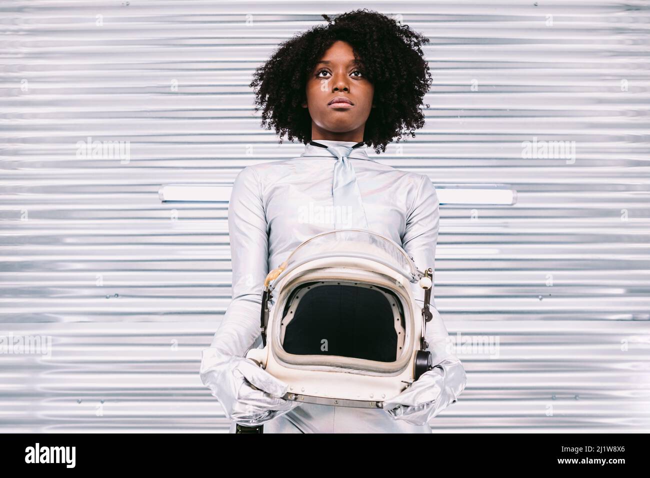 Charming African American female with helmet in white astronaut costume ...