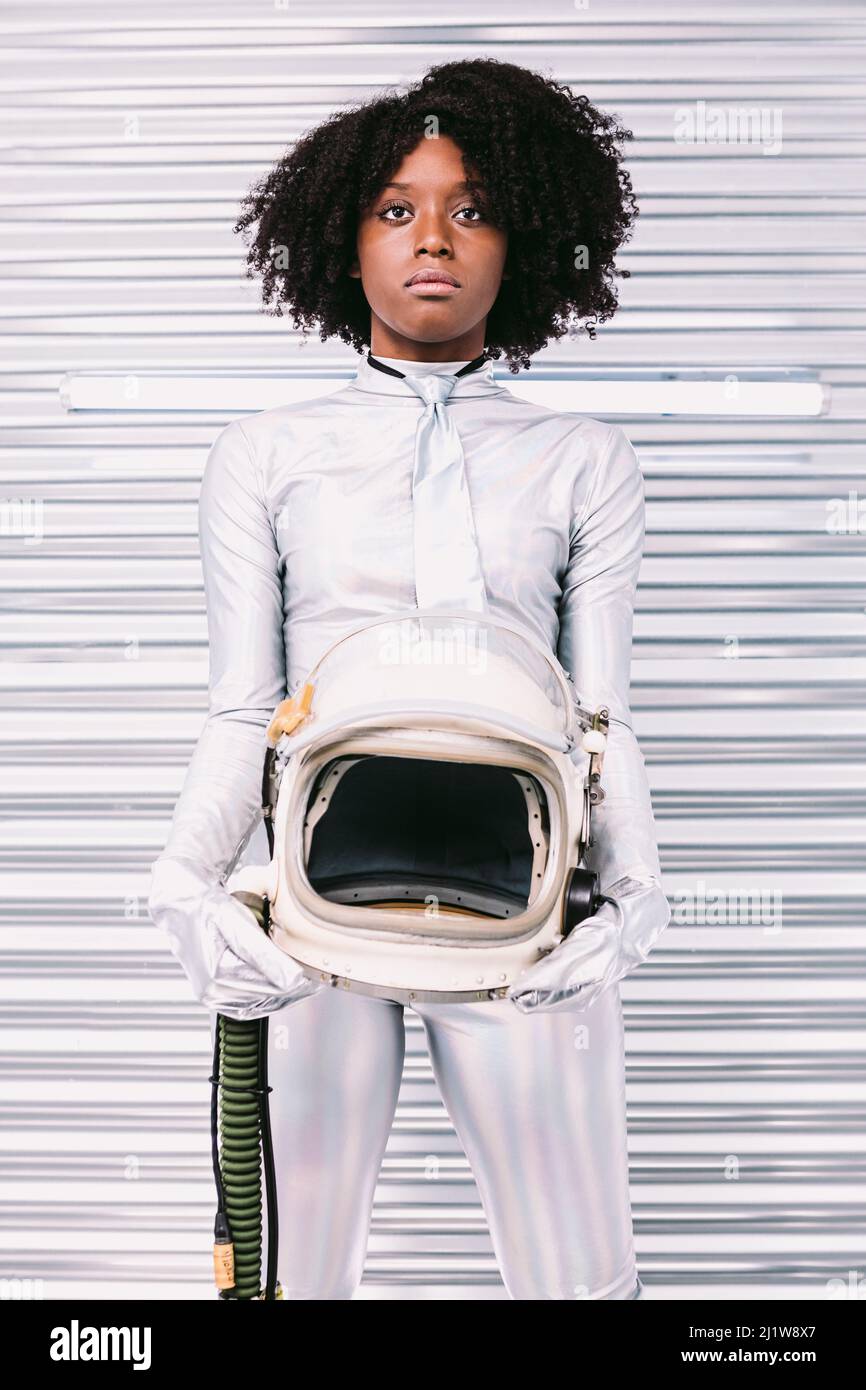 Charming African American female with helmet in white astronaut costume ...