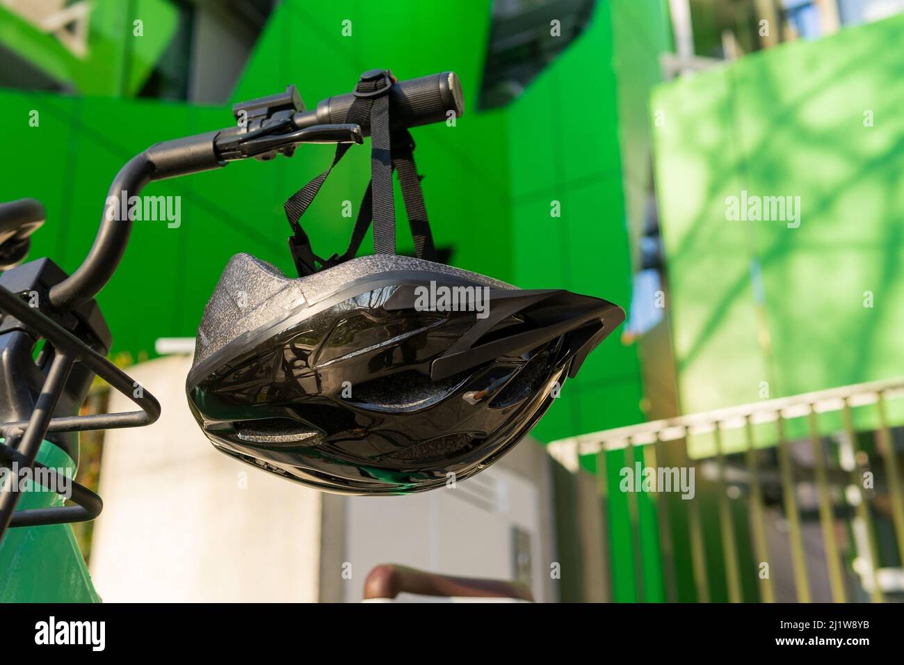 Low angle of protective helmet hanging on bike handle for preventing ...