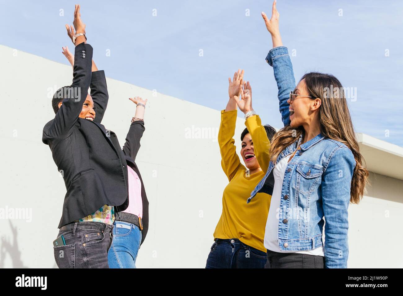 Diverse female friends raising hi-res stock photography and images - Alamy