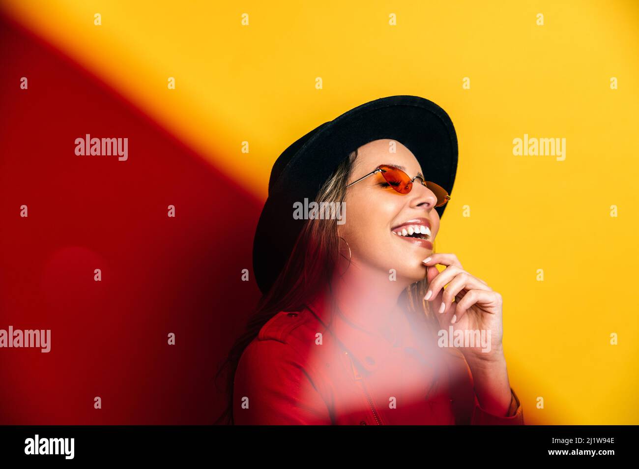 Side view of happy Hispanic female model in trendy sunglasses, hat and ...
