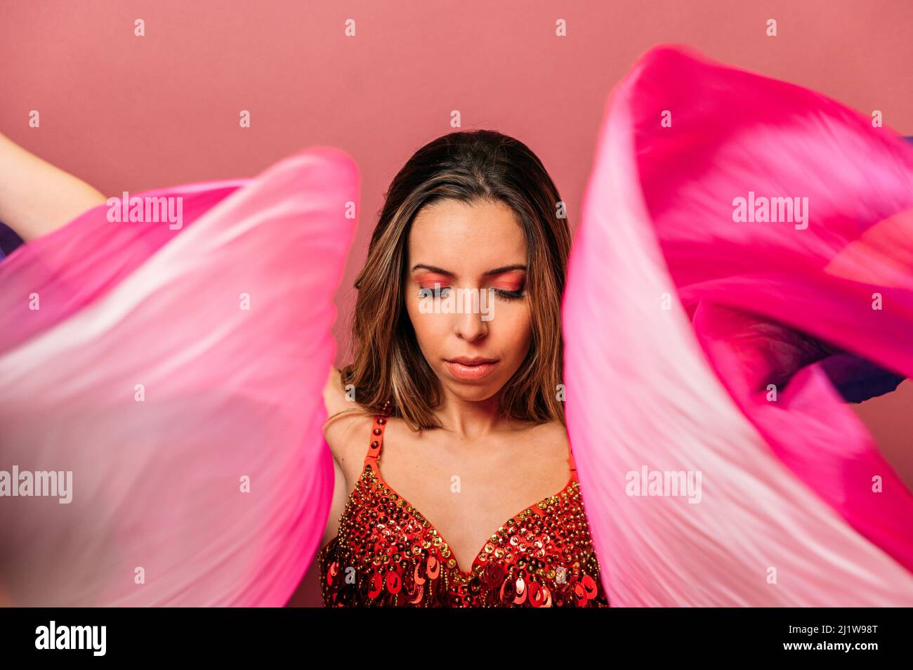 female Hispanic female dancer wearing red bra decorated with sequins ...
