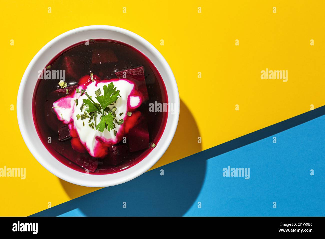 From above of bowl with tasty borscht made with beetroot on background ...