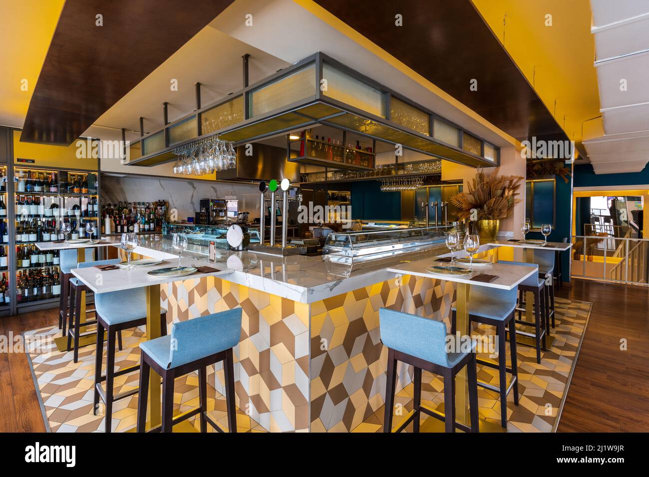 Interior design of contemporary restaurant with stool at tables with ...