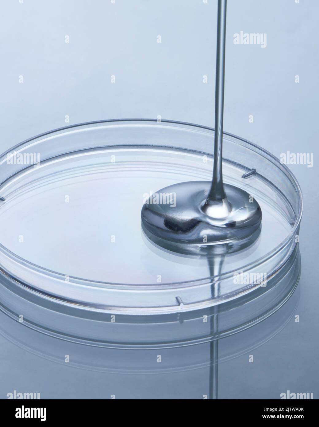 Gooey transparent Hyaluronic acid for skin care pouring into round ...