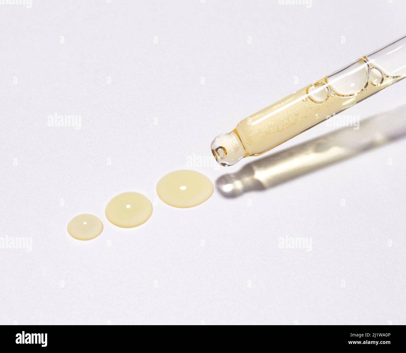 From above glass pipette with yellow Hyaluronic acid for skin care on ...