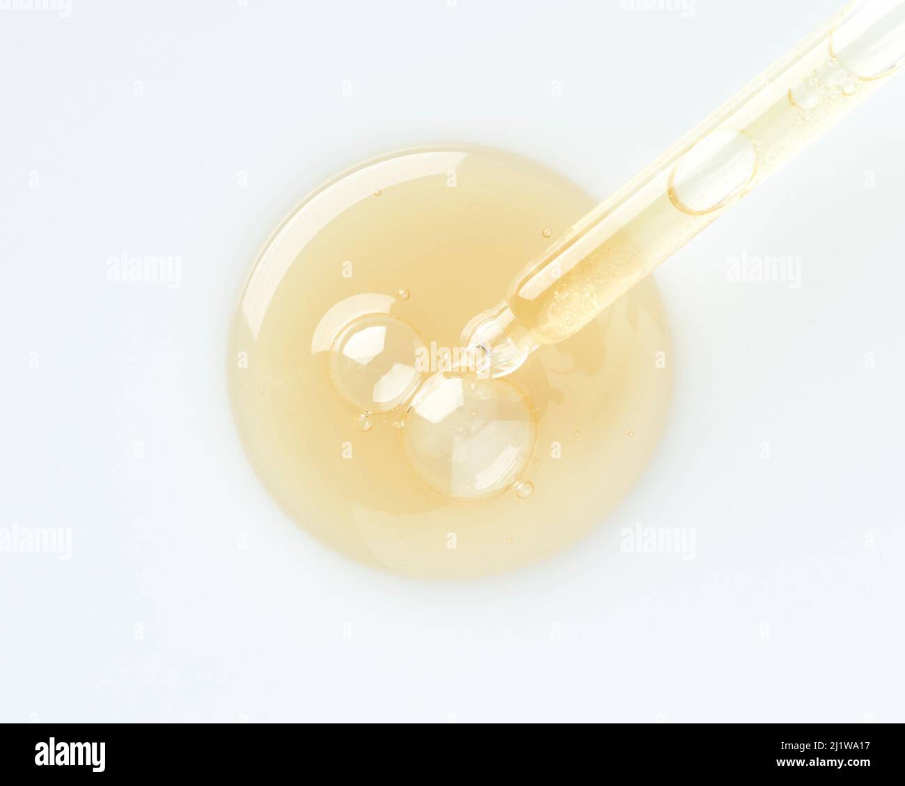 Top view of glass pipette with yellow Hyaluronic acid for skin care on ...